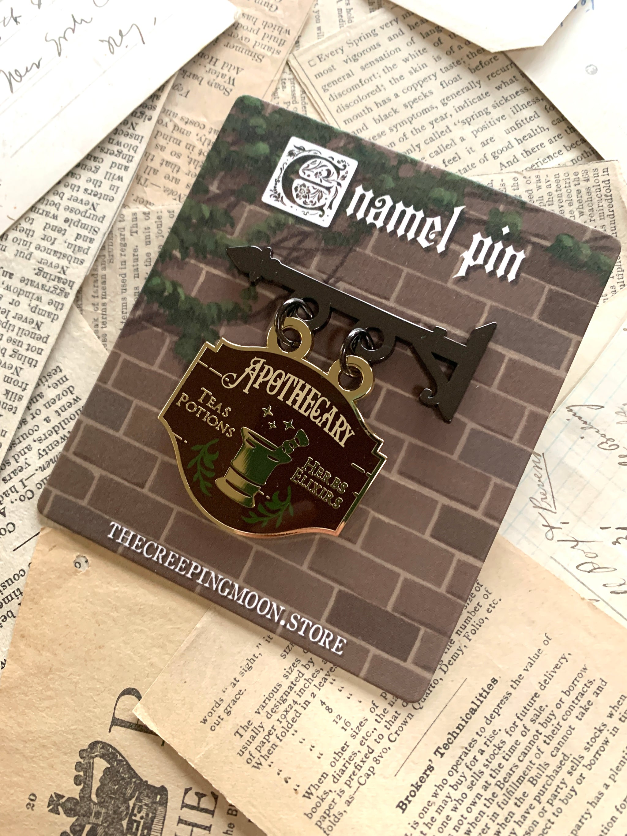 Apothecary shop sign enamel pin – The Creeping Moon